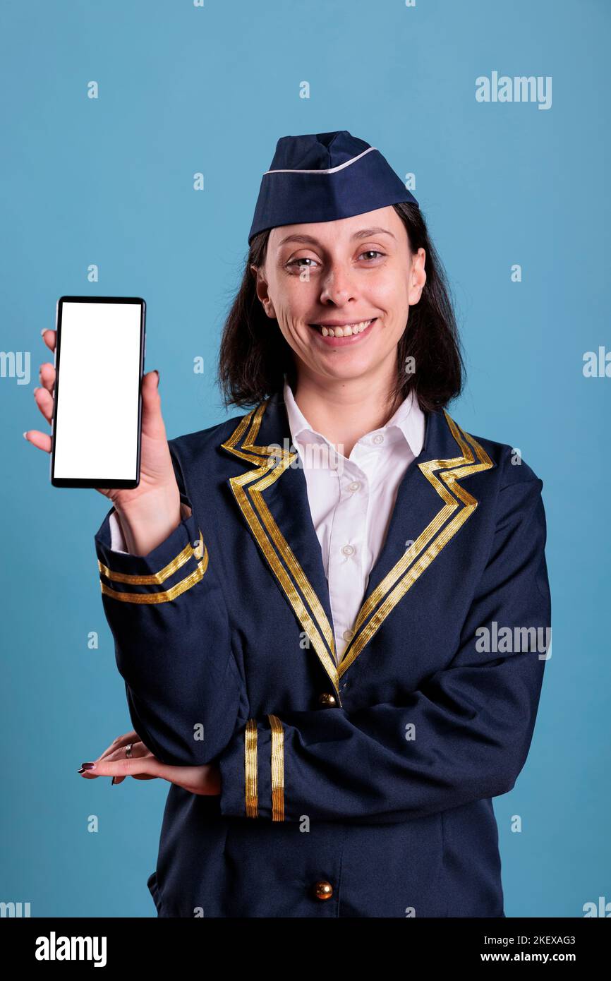 Smiling stewardess holding smartphone hi-res stock photography and ...