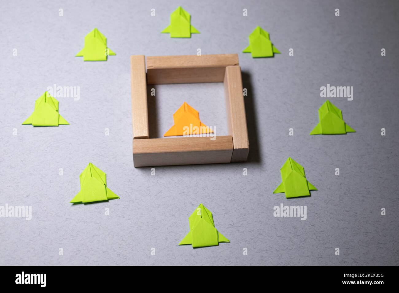 Conceptual paper cars of yellow, green and red colors on a colored ...