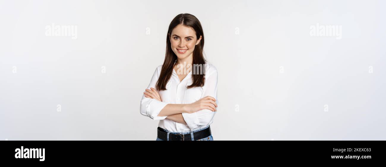 Smiling young businesswoman, female entrepreneur in white shirt, cross ...