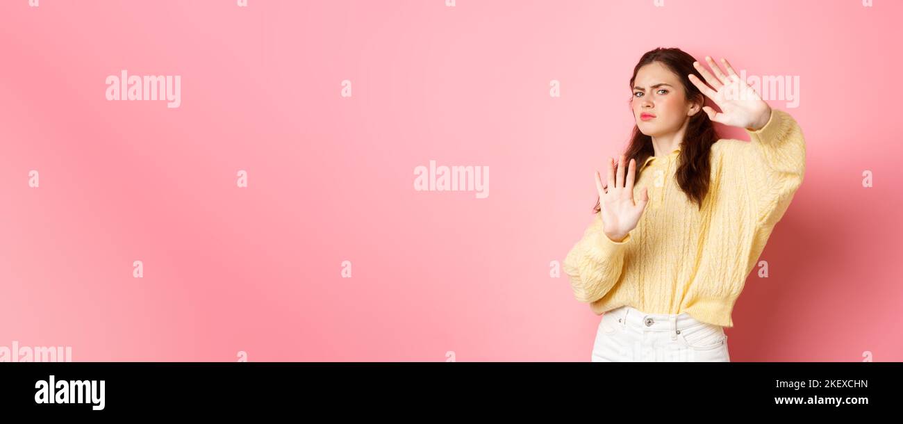 Please stop, enough. Displeased and reluctant young woman stay back ...