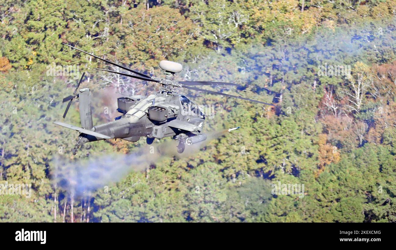 An AH-64E Apache Guardian helicopter fires Hydra-70 2.75-inch rockets ...