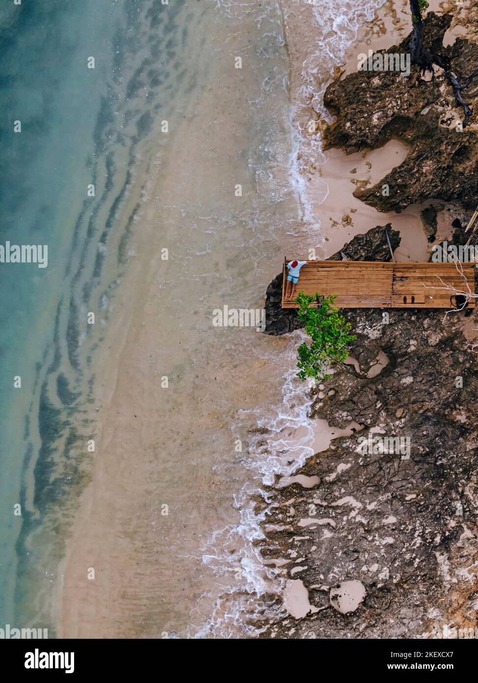 Man sitting on pier over sea at the coast, Java, Indonesia Stock Photo ...