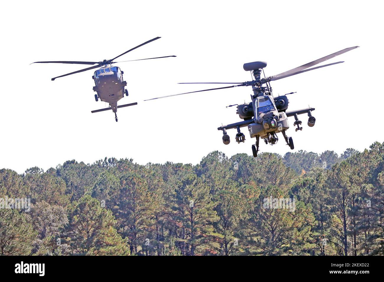 An AH-64E Apache Guardian and UH-60M Black Hawk helicopter conduct a ...