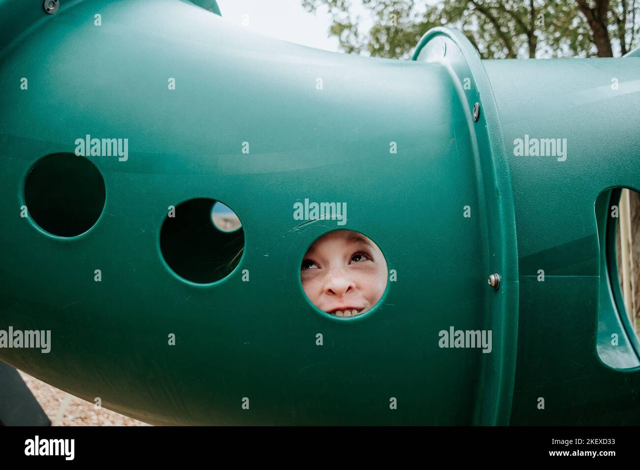 Goofy child playing on a playground Stock Photo - Alamy