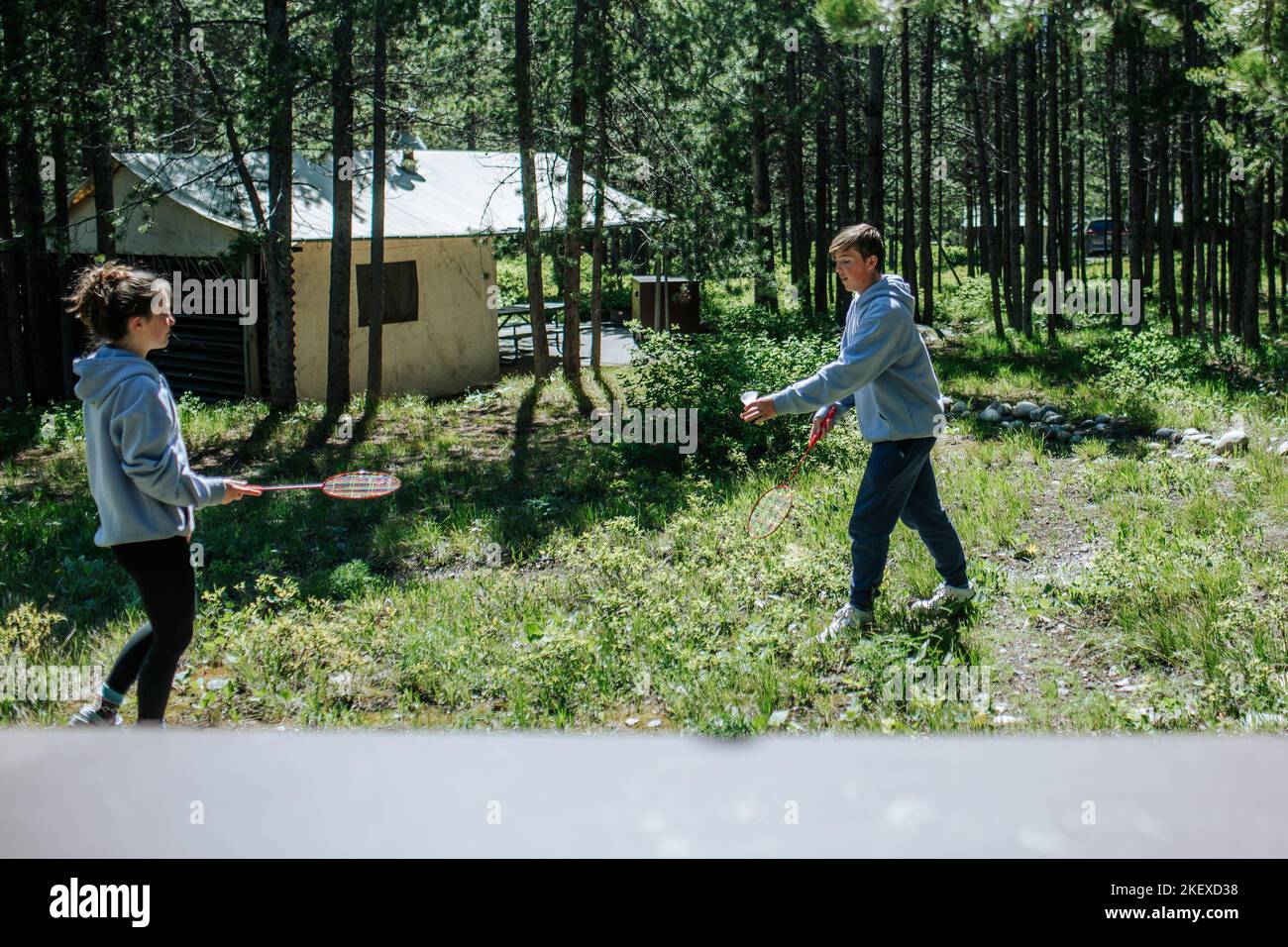 Two teenagers playing badminton outside at campground Stock Photo - Alamy