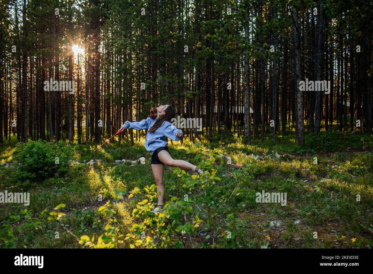 Teen girl playing badminton outside in campground Stock Photo - Alamy
