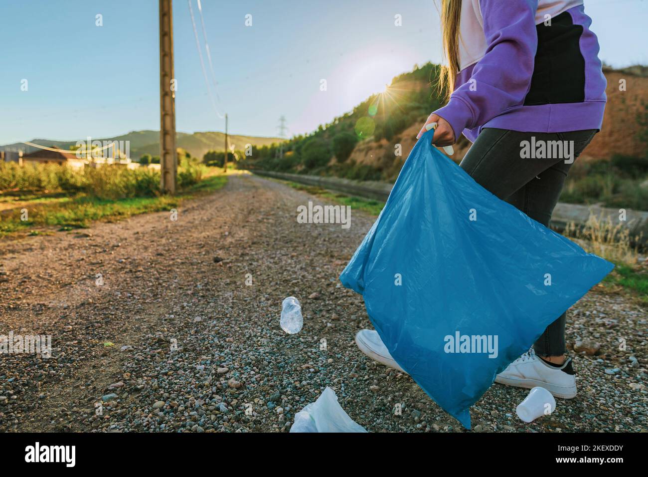 Girl recycling garbage with gloves and a plastic bag Stock Photo - Alamy