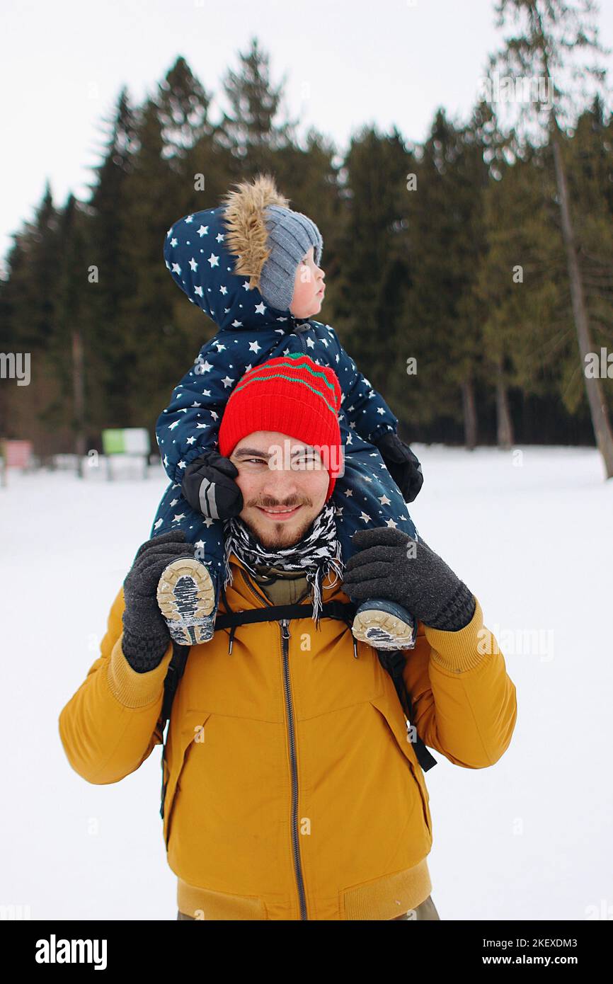 Boy sitting on fathers shoulders Stock Photo - Alamy