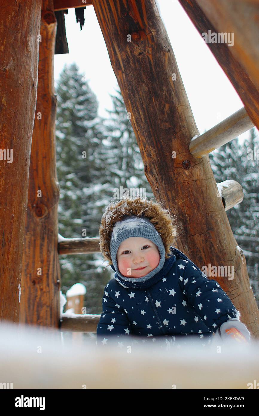 Boy hiding in wooden house in winter Stock Photo - Alamy