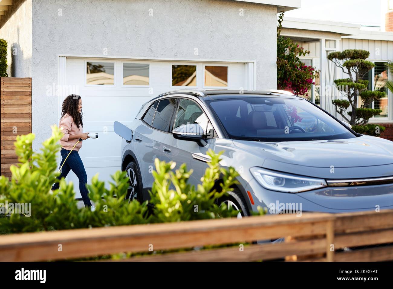 Home charging station woman hi-res stock photography and images - Alamy