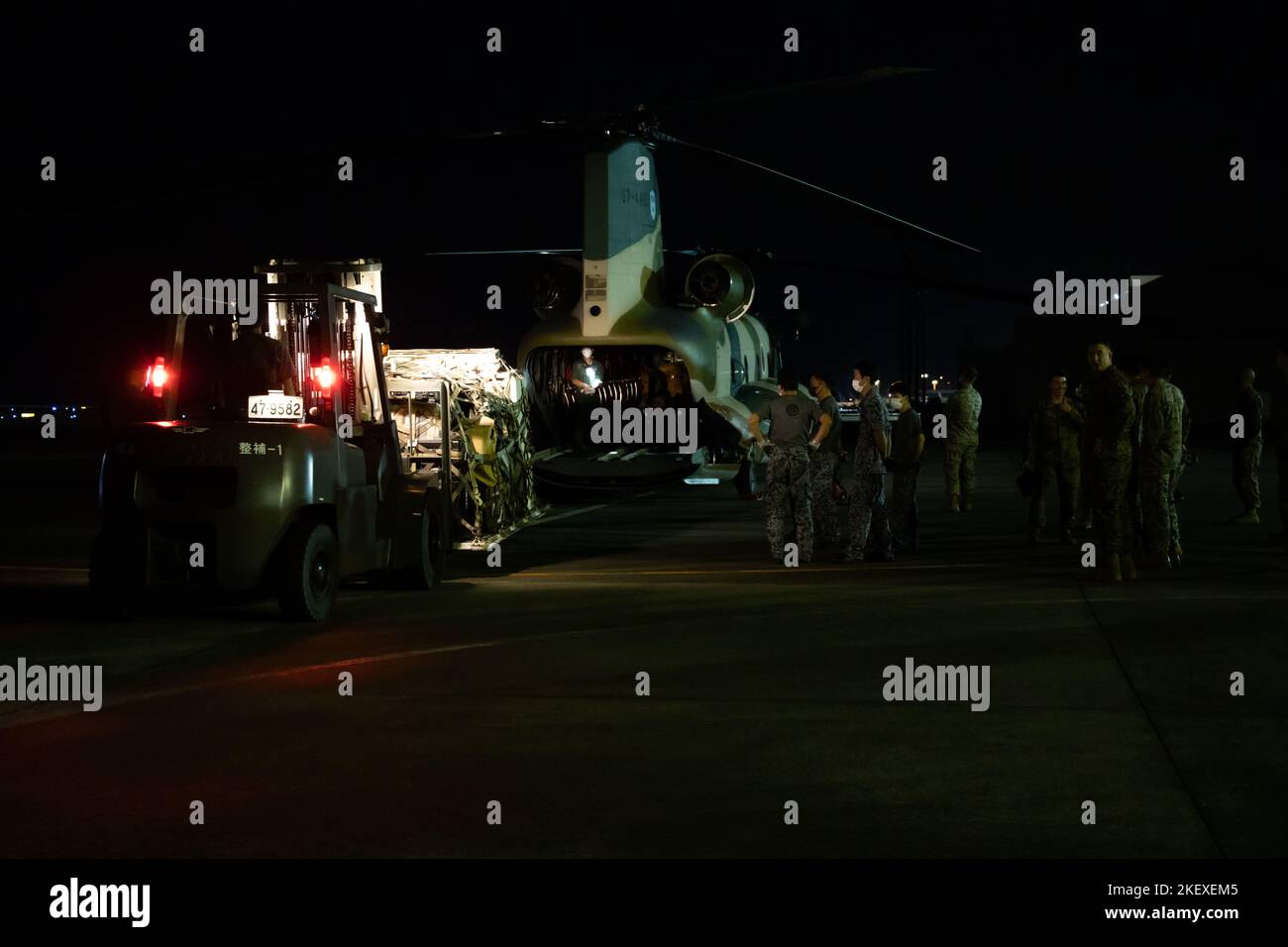 U.S. Marines with 12th Marine Regiment, 3d Marine Division, load gear ...