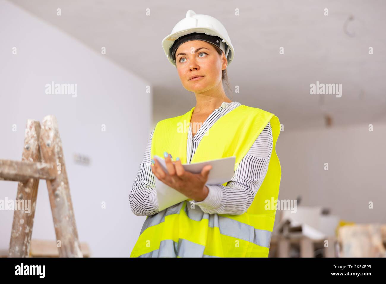 Female civil engineer making notes at construction site Stock Photo - Alamy