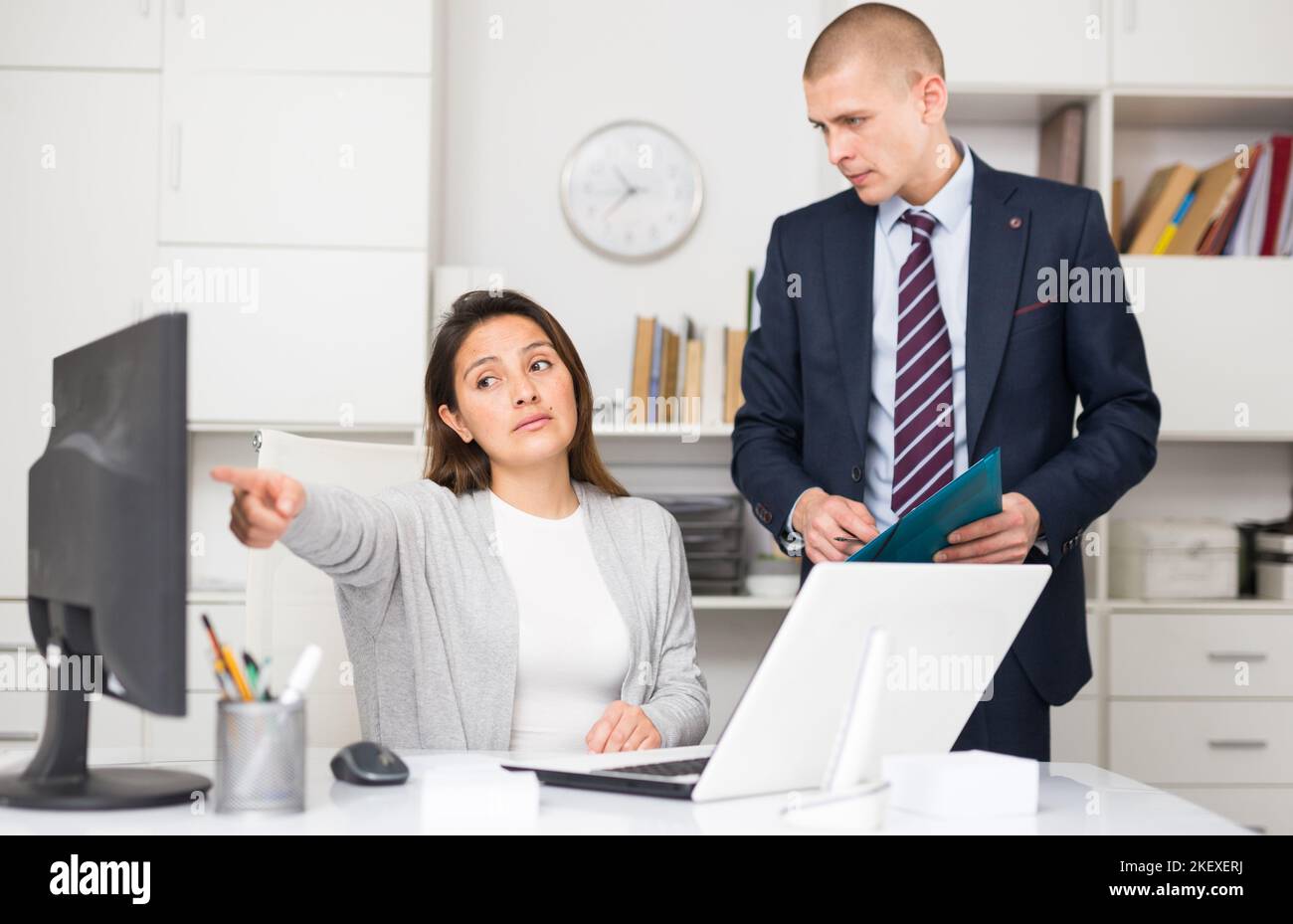 Upset man standing next to disgruntled female boss Stock Photo - Alamy