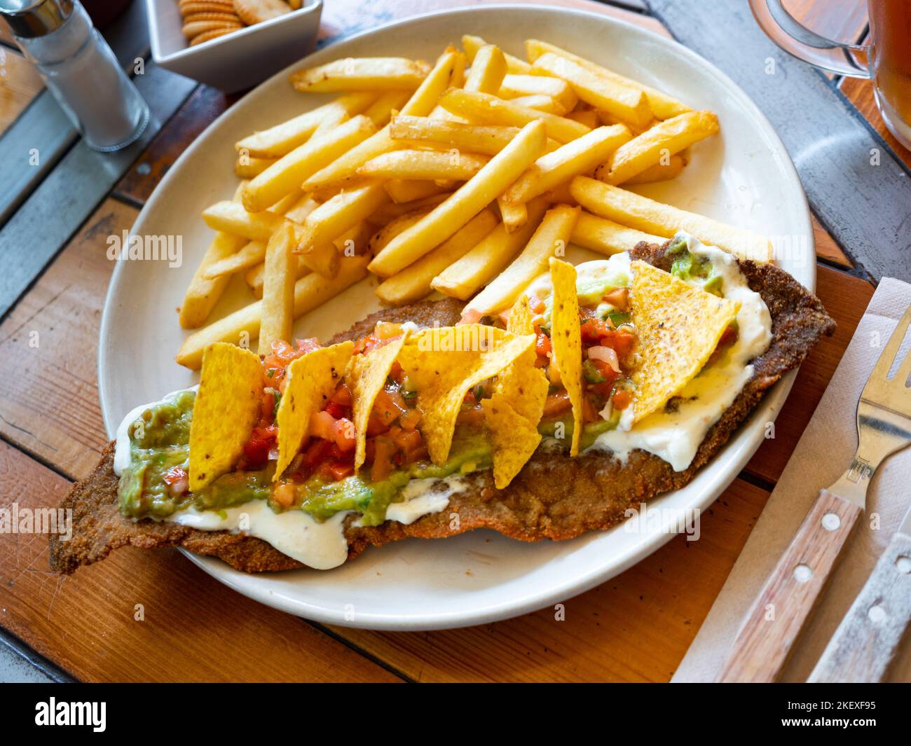 Portion of just cooked Mexican milanesa with french fries Stock Photo - Alamy
