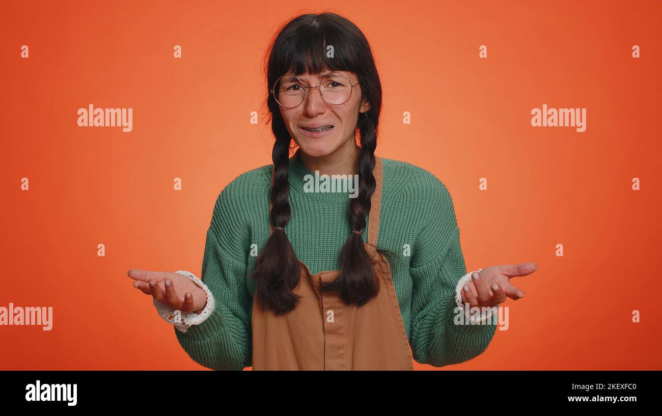 What Why. Sincere irritated adult woman raising hands in indignant ...