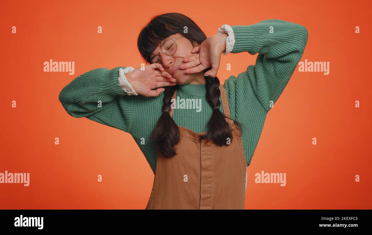 Tired lovely millennial woman in green sweater yawning sleepy ...