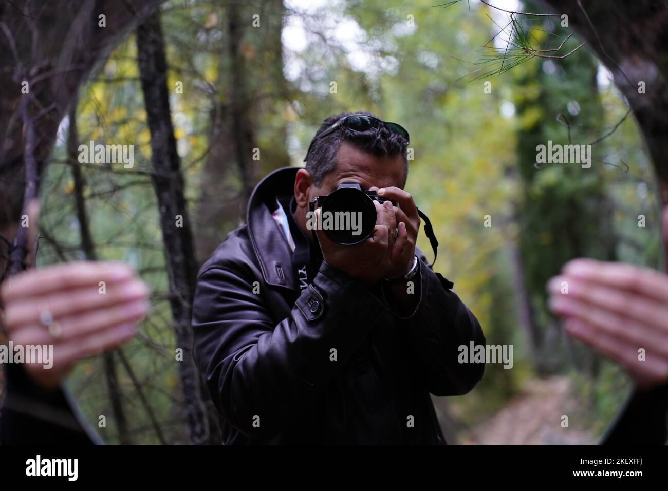 photographer photo shooting a girl holding a mirror in forest Stock ...