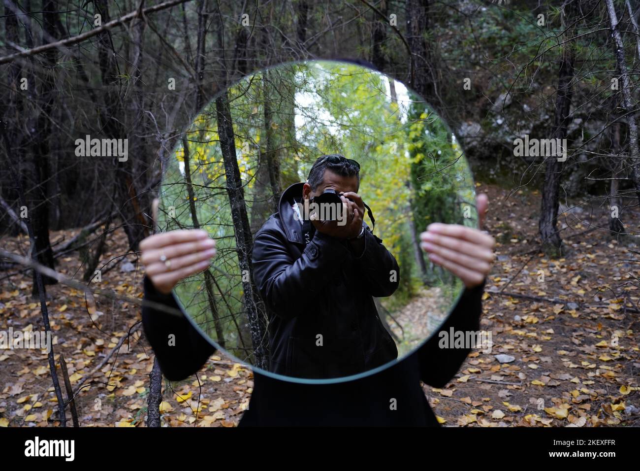 photographer photo shooting a girl holding a mirror in forest Stock ...