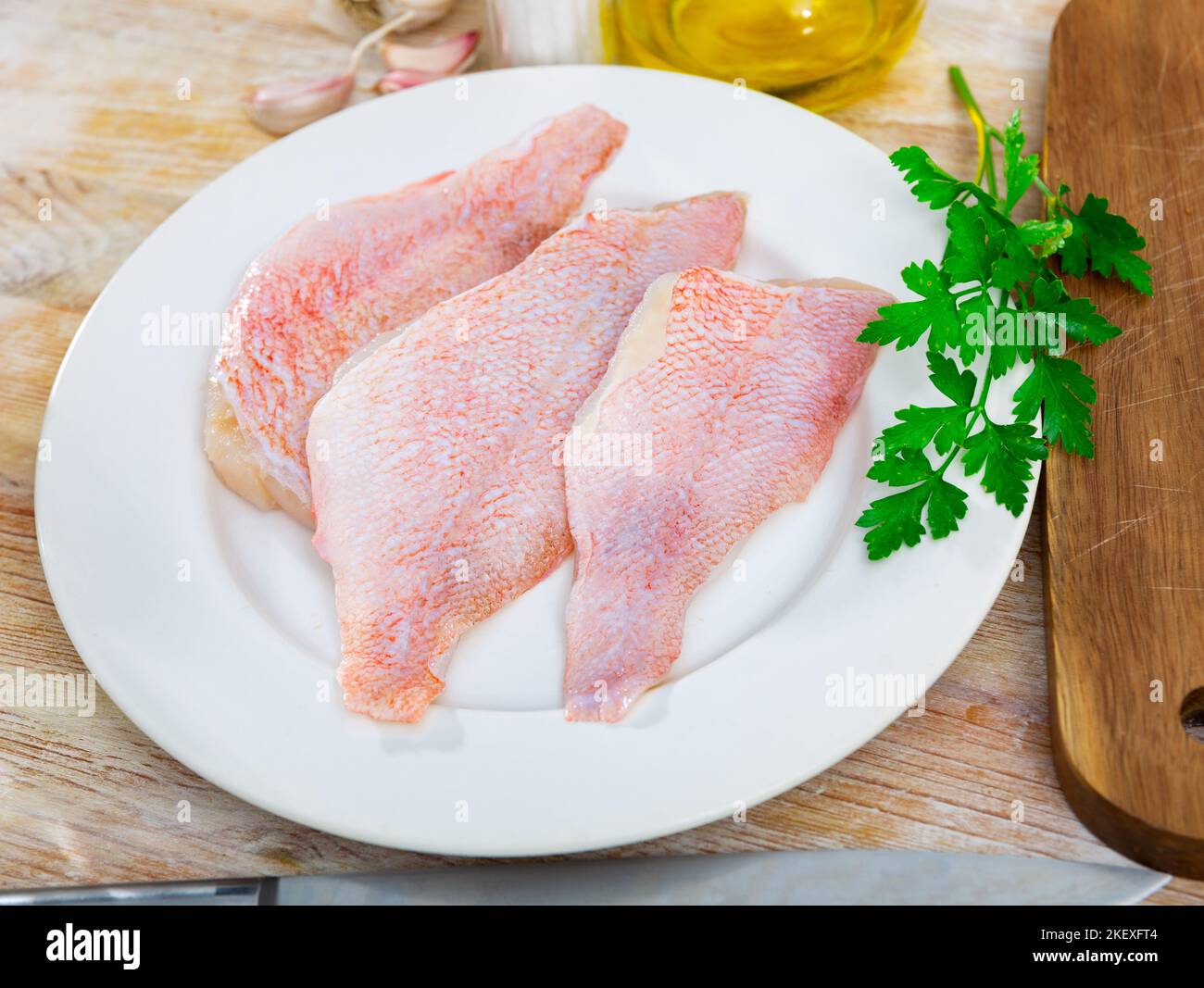 Raw rockfish fillet with condiments, cooking ingredients Stock Photo ...