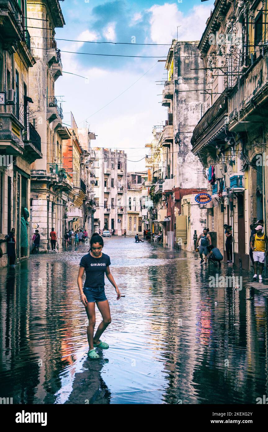 Girl walking on water after a flood. Havana, Cuba Stock Photo - Alamy