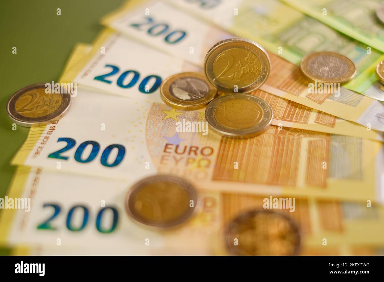 Finance and savings. euro coins and Two hundred euro banknotes on a ...