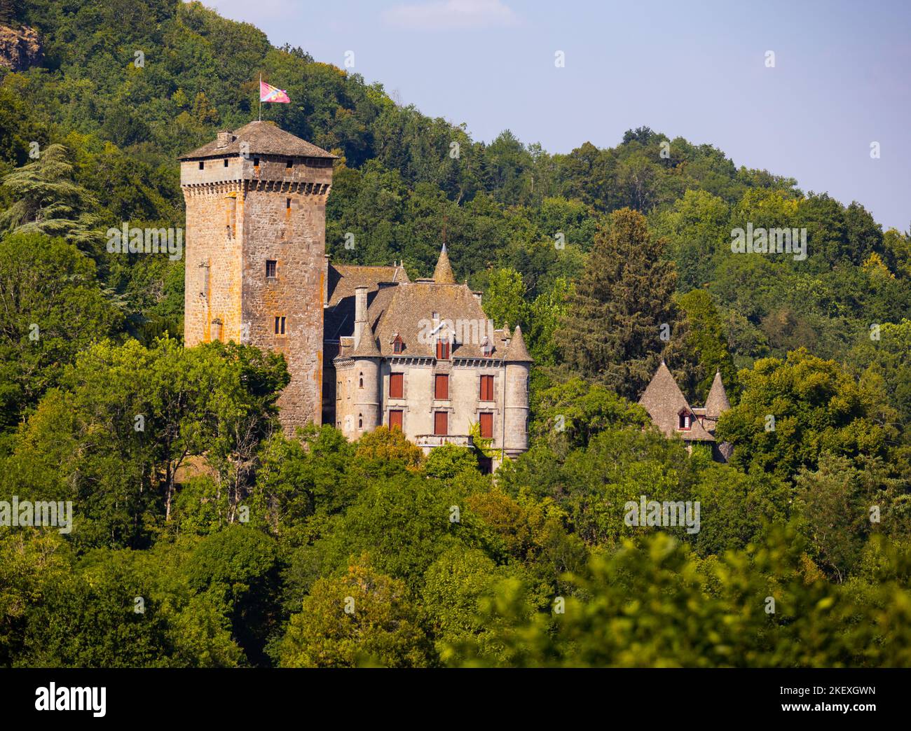 Medieval Pesseils Castle on hillside among greenery on summer, France ...