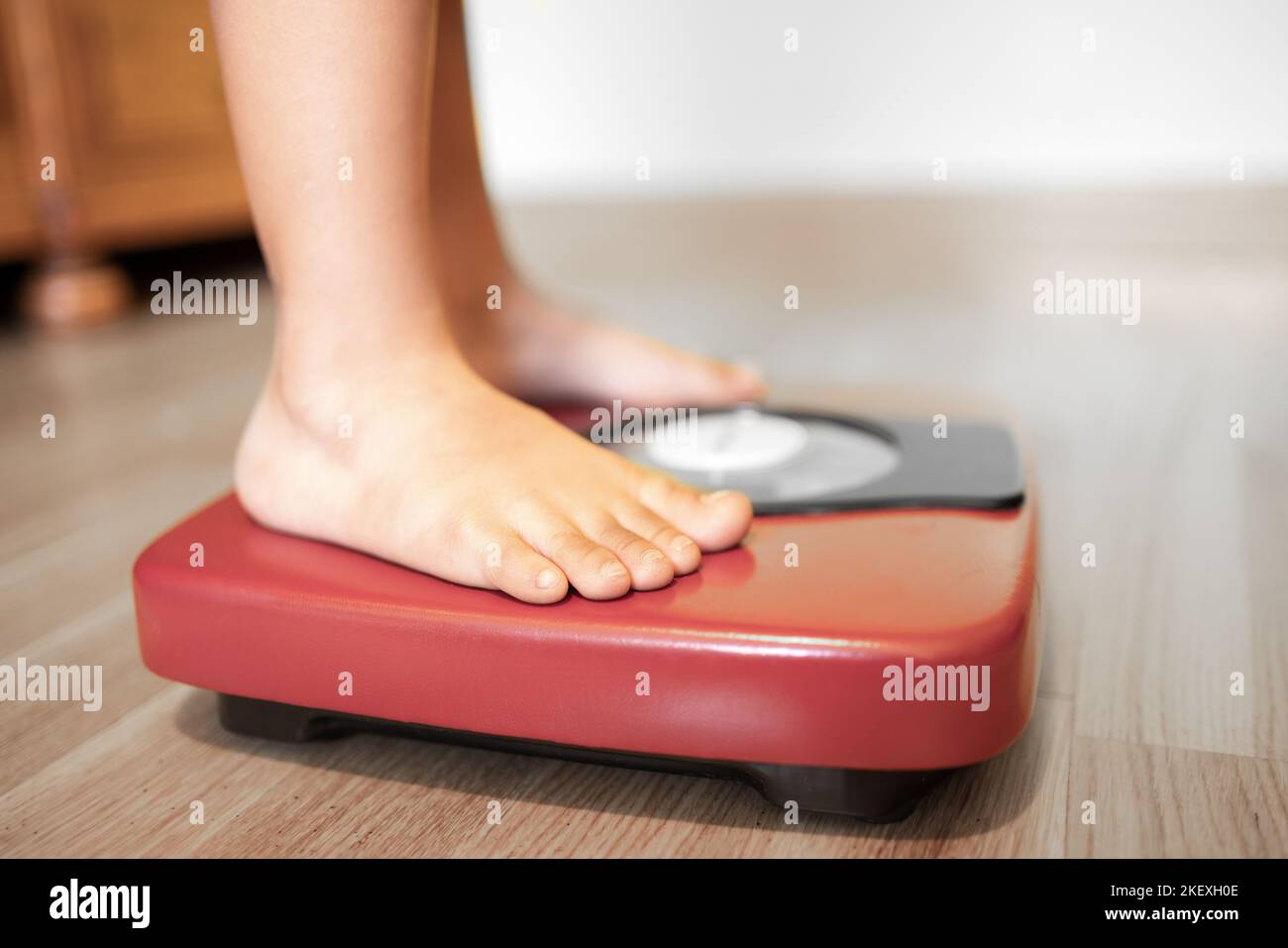 Side view of scales on a floor and kids feet at room Stock Photo - Alamy
