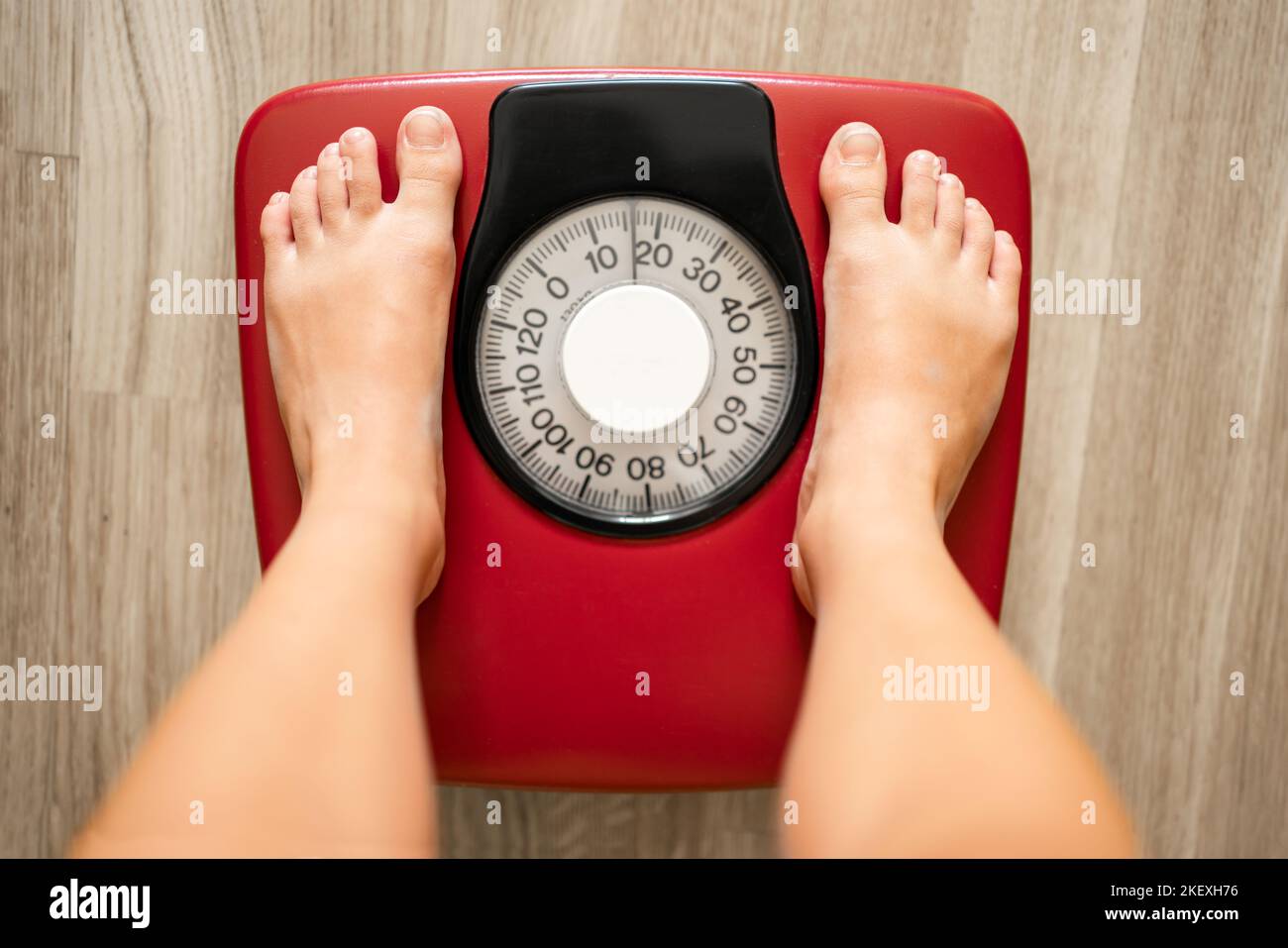 Top view of scales on a floor and kids feet at room Stock Photo - Alamy