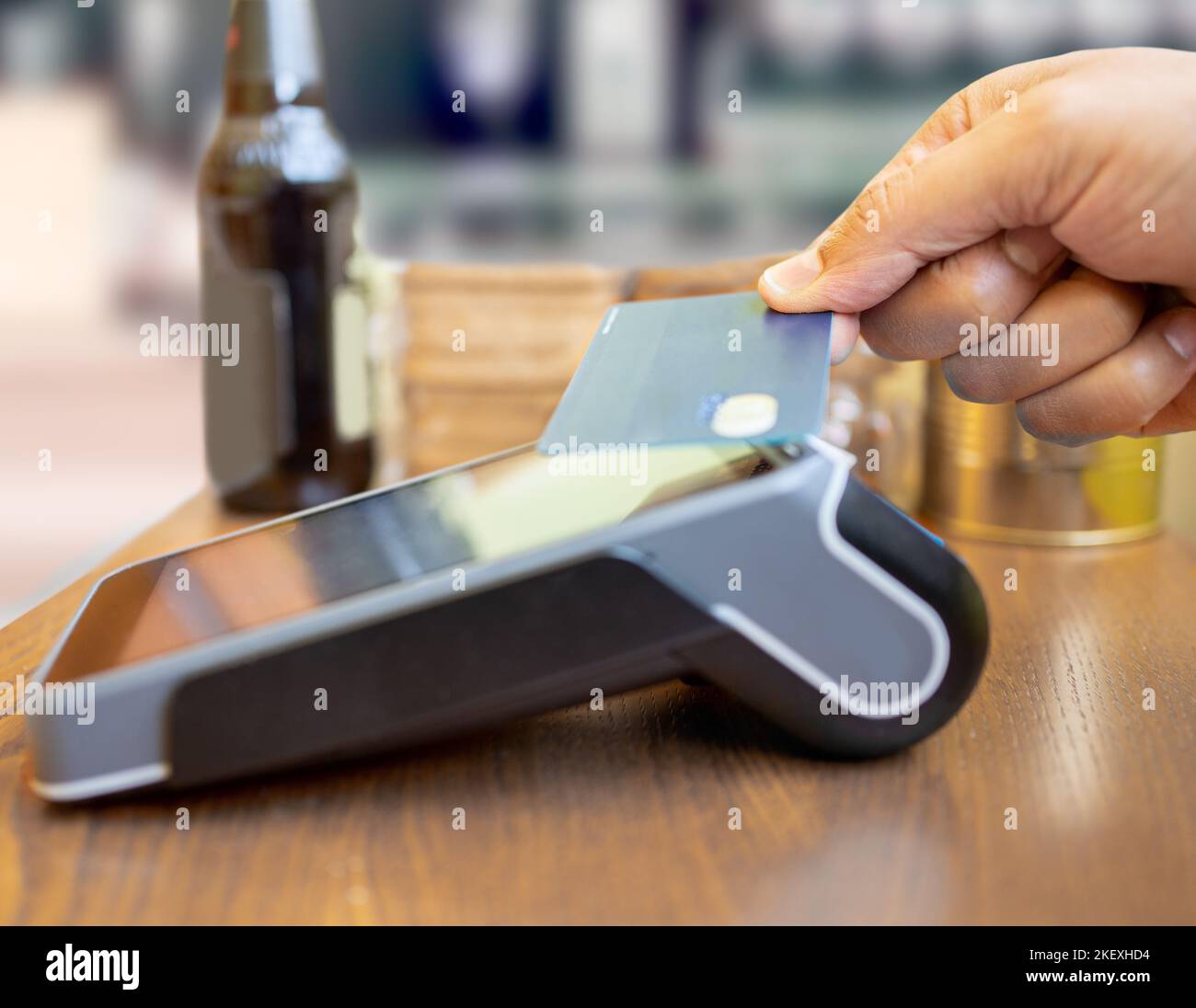 Side view of credit card contactless payment at shop Stock Photo - Alamy