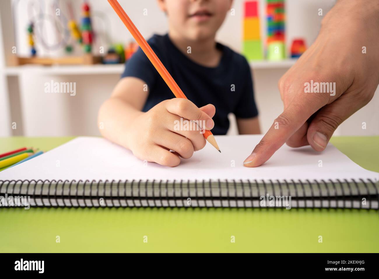 Mom helping elementary age son with school homework. Concept of mother ...