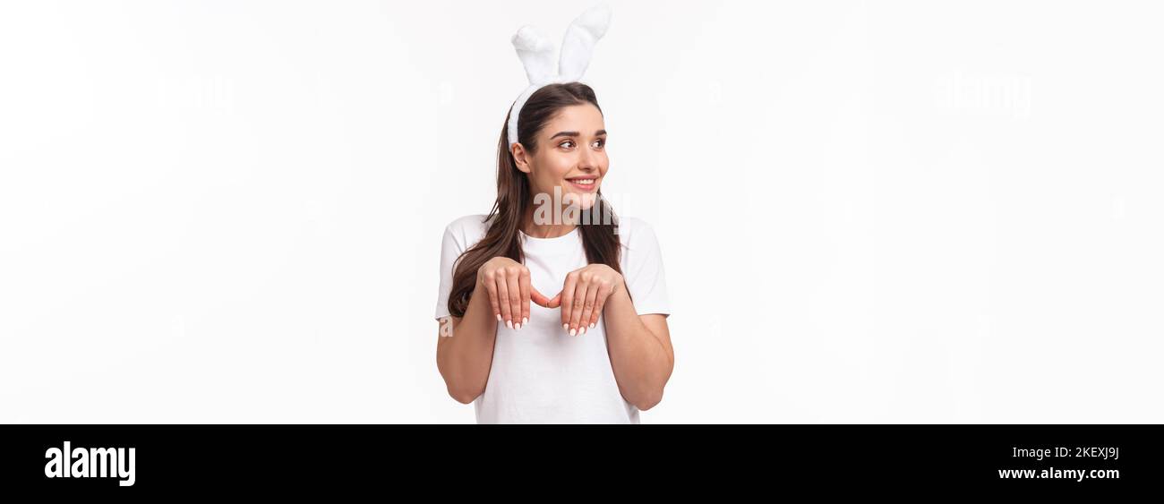 Portrait of funny and cute, playful adult girl in t-shirt and rabbit ...