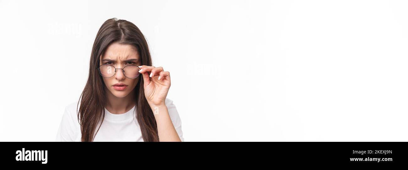Close-up portrait of suspicious young serious-looking woman, look from ...