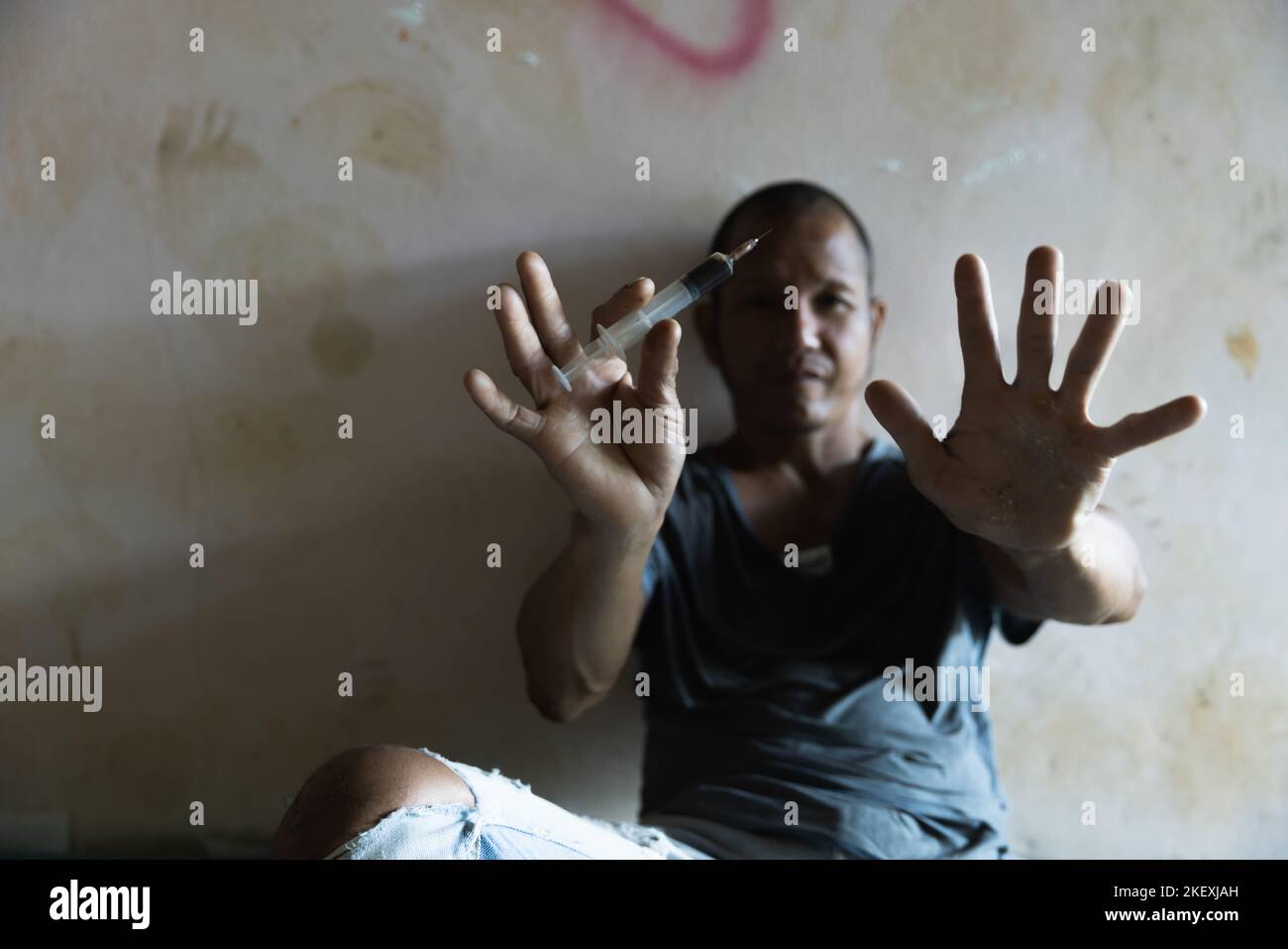 Human hand trying to reach, on concrete floor. Drugs addiction and ...