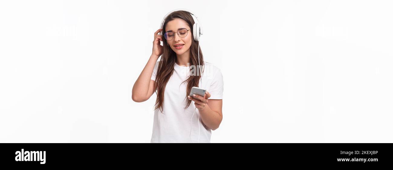Technology, lifestyle and music concept. Portrait of pleased and ...