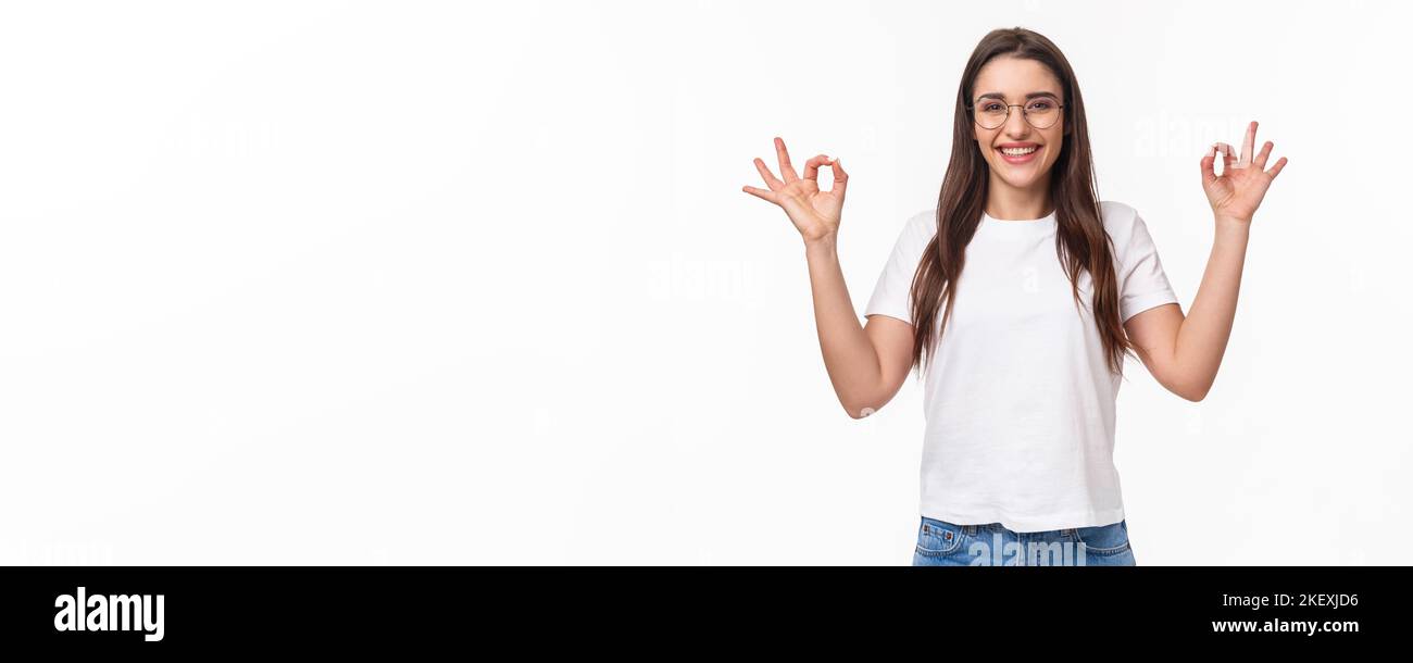 Waist-up portrait of smiling happy attractive girl in glasses and t ...