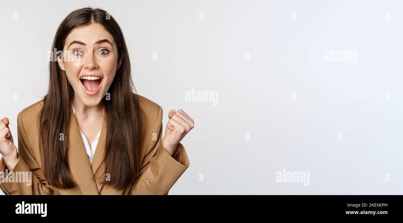 Enthusiastic girl screaming and rejoicing, looking at camera, winning ...