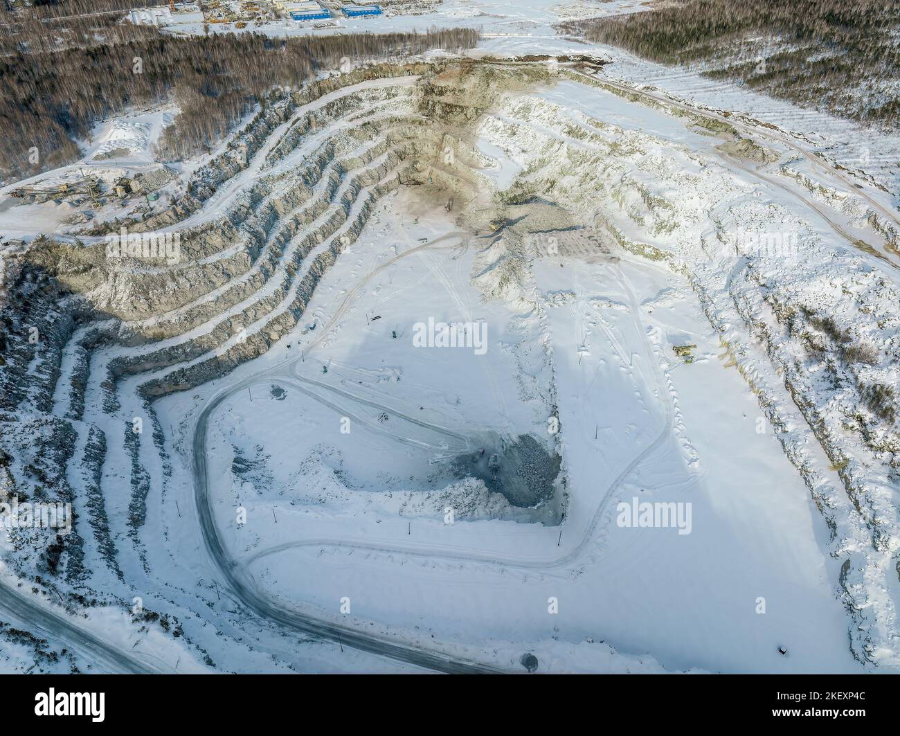 Aerial view to crushed stone quarry in winter with snow. Crushed stone ...