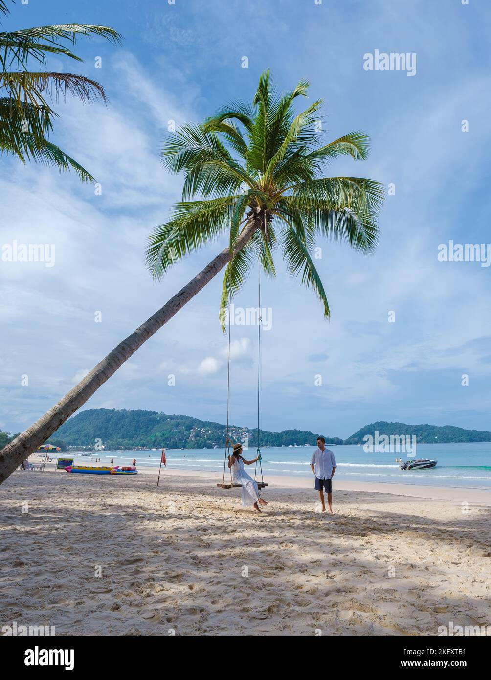 Man sitting under palm tree hi-res stock photography and images - Alamy