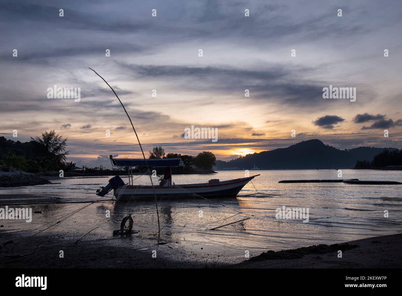 sunset scene of the fishing boats harbored at the seaside Stock Photo ...