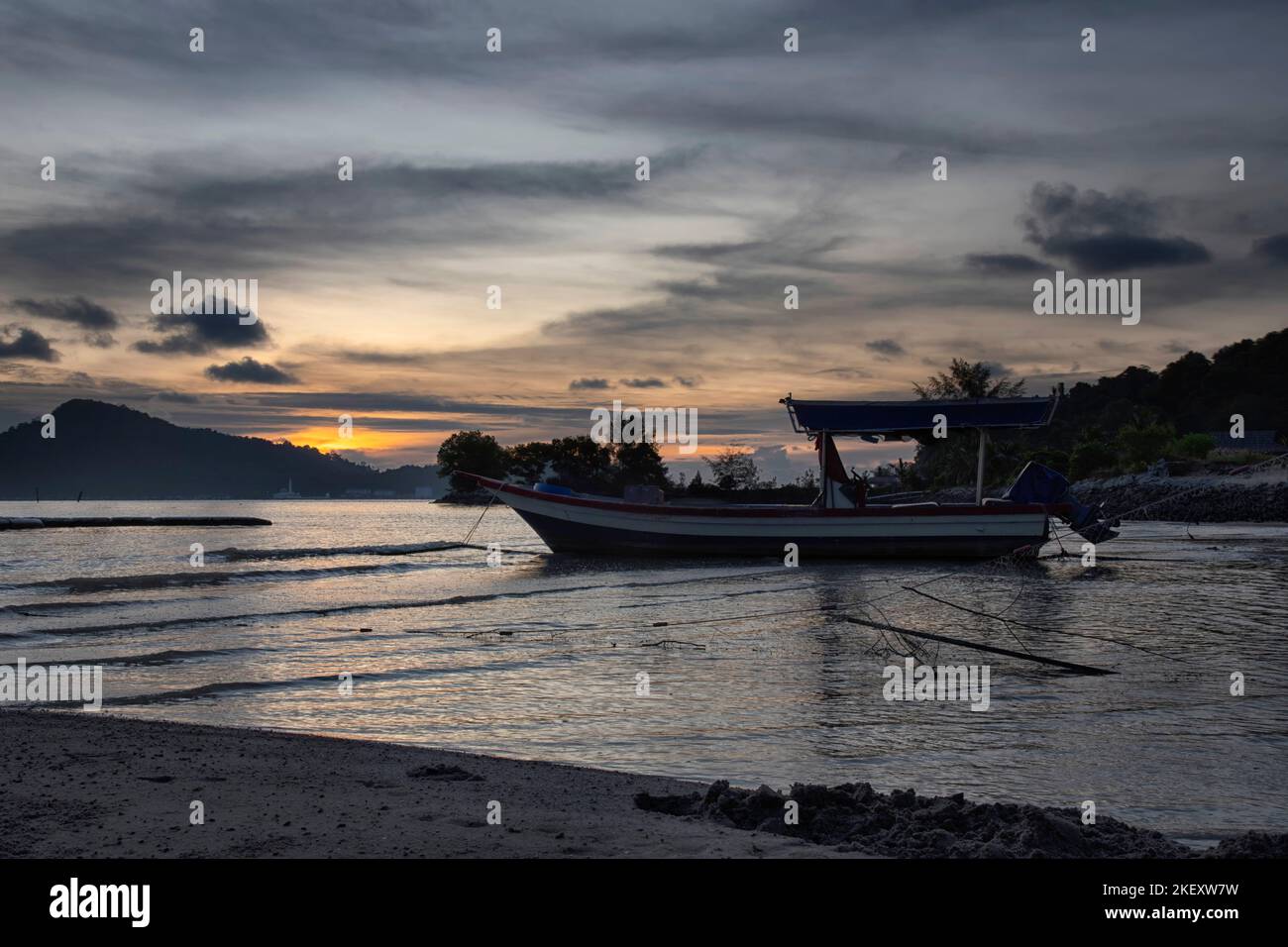 sunset scene of the fishing boats harbored at the seaside Stock Photo ...