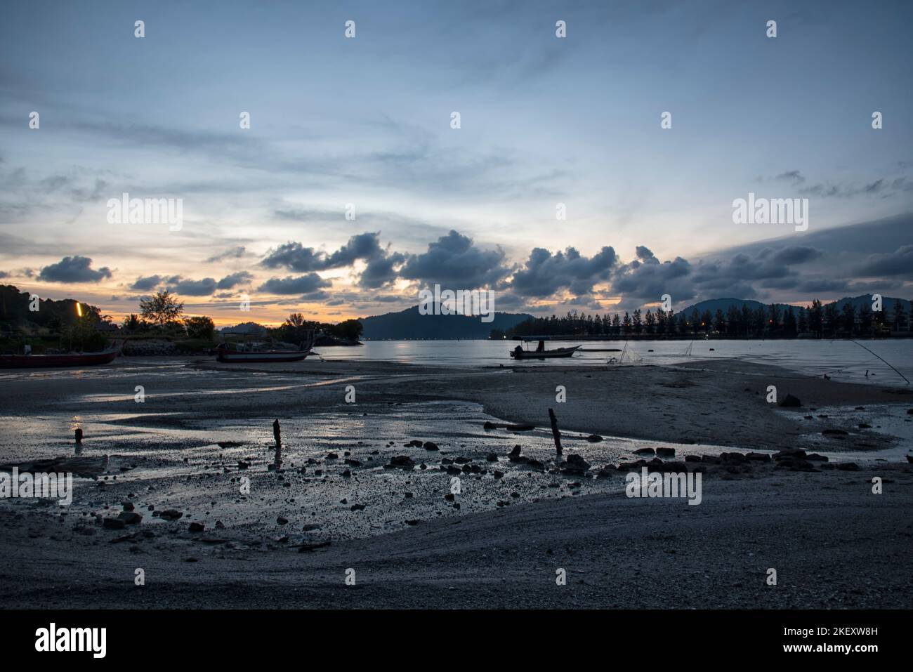 sunset scene of the fishing boats harbored at the seaside Stock Photo ...