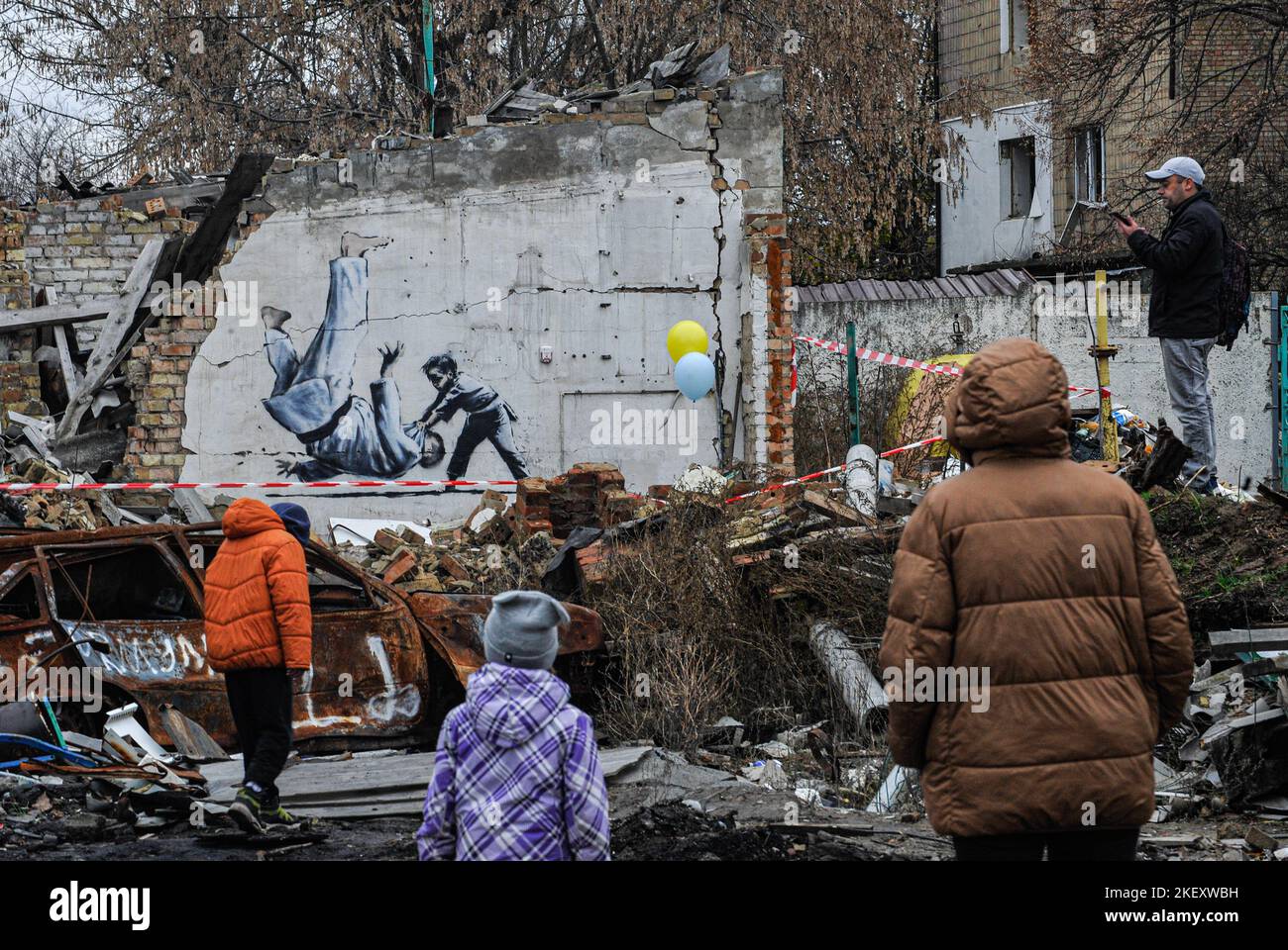 Borodyanka, Ukraine. 14th Nov, 2022. People look at the graffiti made ...