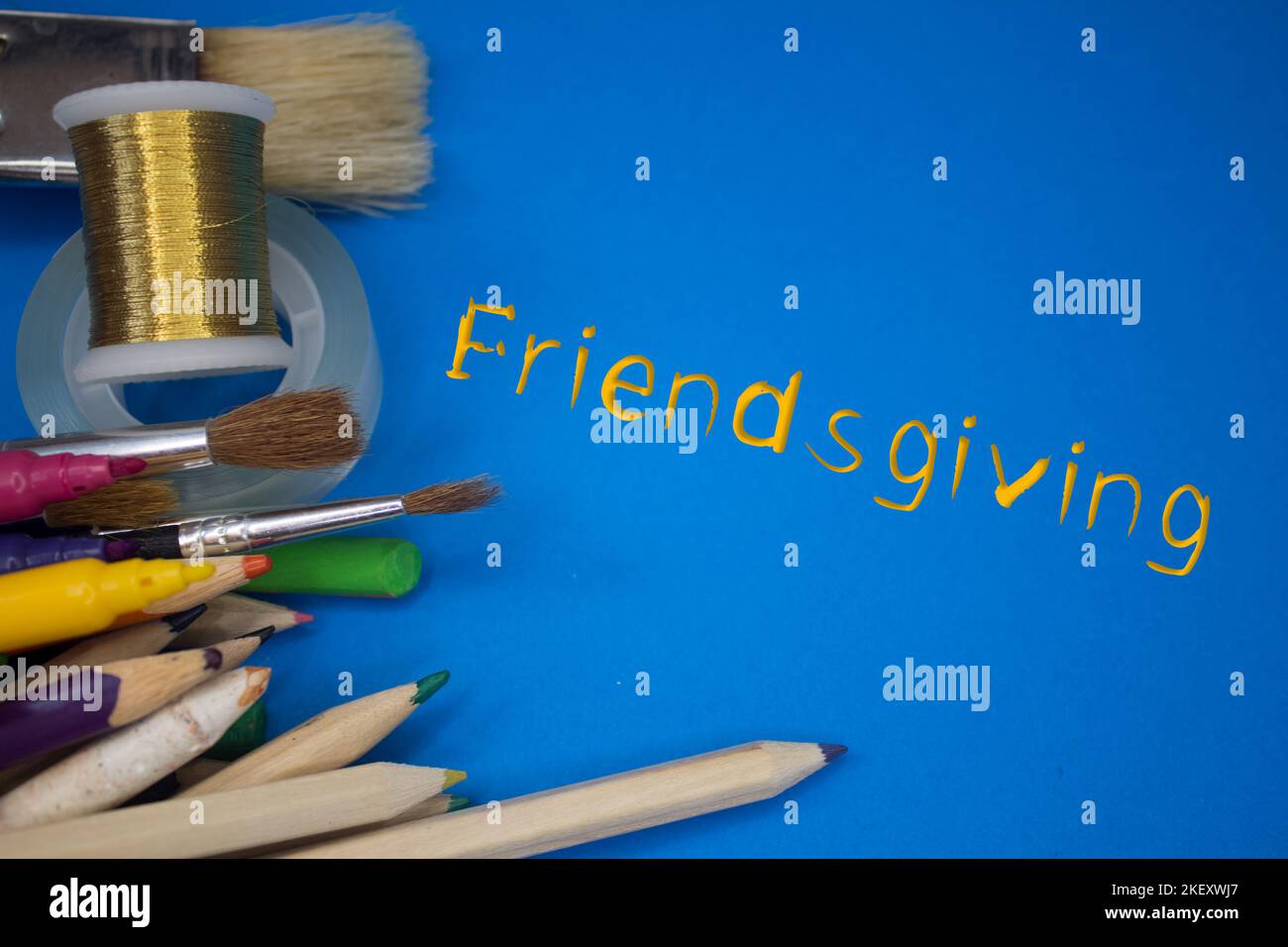 Overhead shot of school supplies with Friendsgiving text. Brushes ...