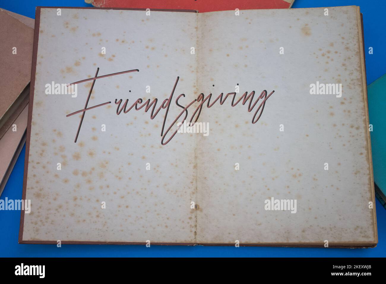 Friendsgiving word in opened book with vintage, natural patterns old ...