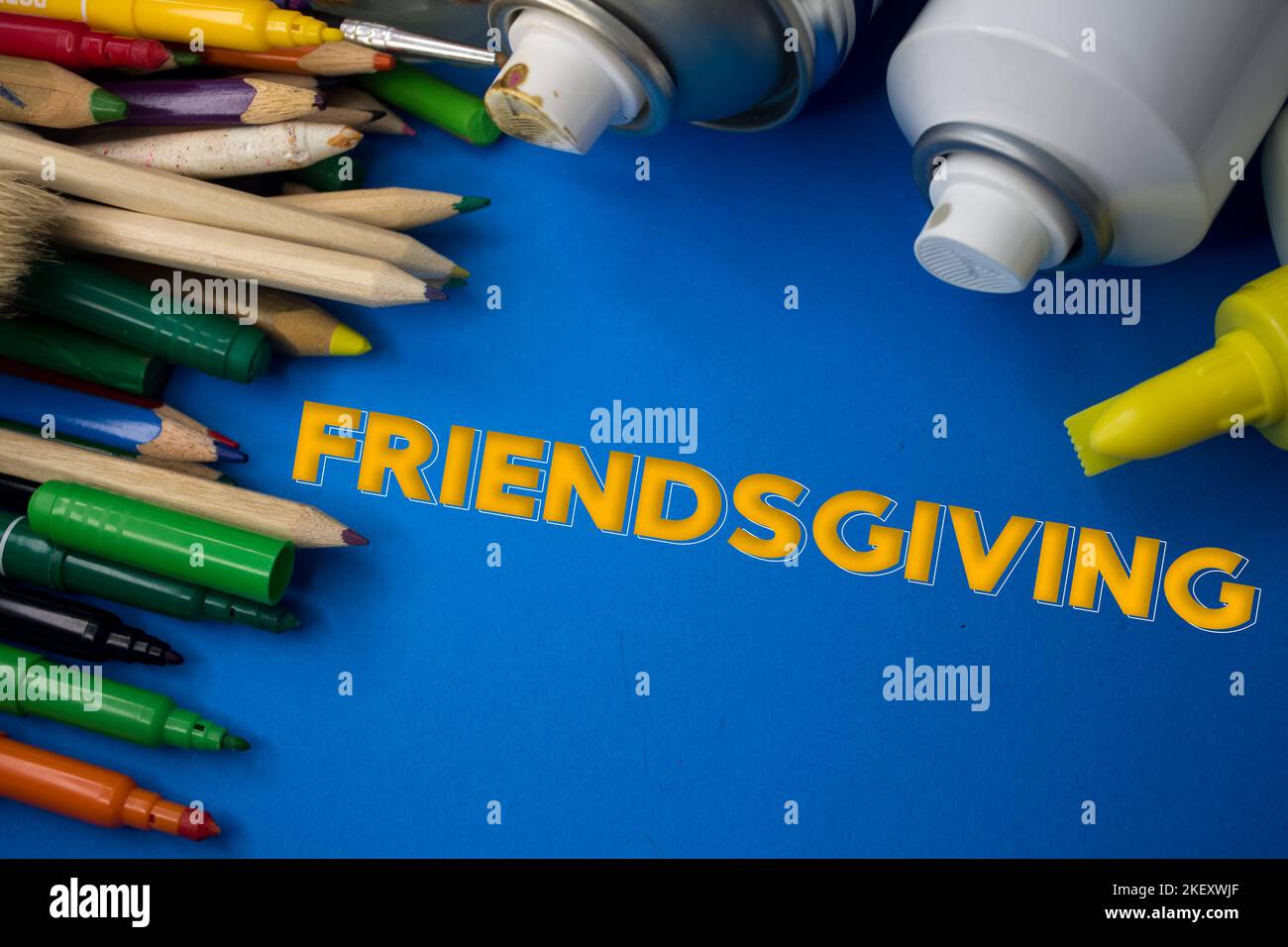 Overhead shot of school supplies with Friendsgiving text. Brushes ...