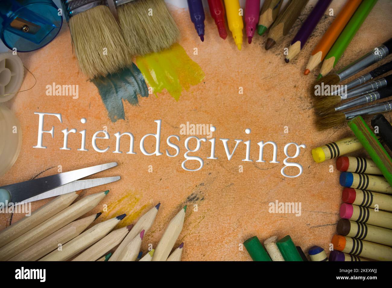Overhead shot of school supplies with Friendsgiving text. Brushes ...