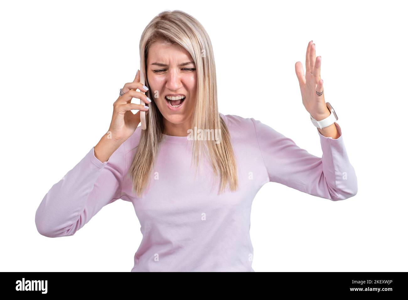 Young woman screaming while talking on the phone isolated on white ...