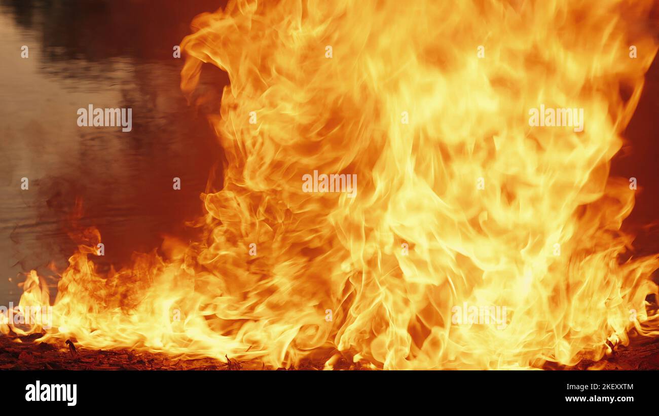 Column of fire on the water surface, on the border with the earth Stock ...