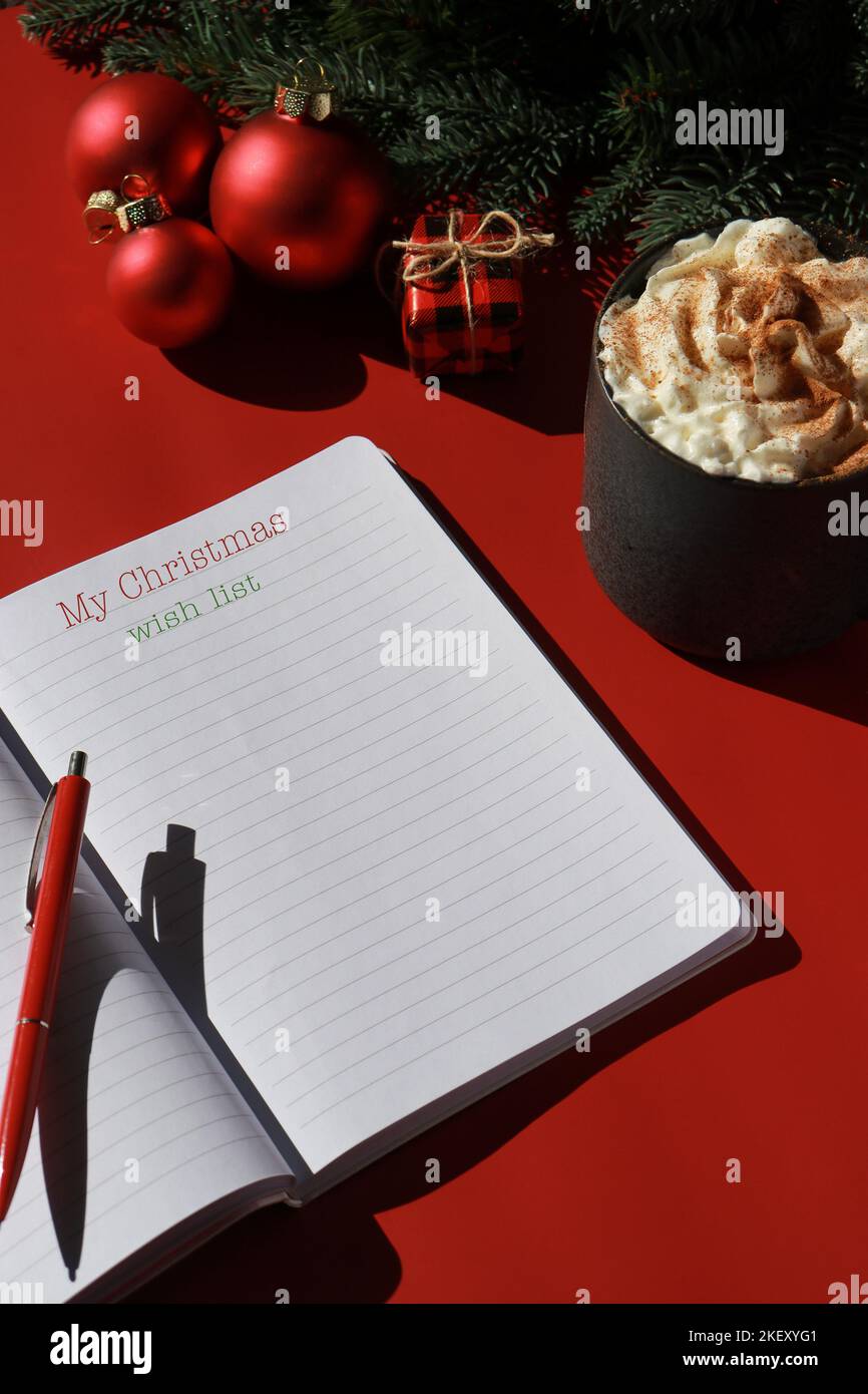red Christmas composition with hot chocolate and note book for wish ...