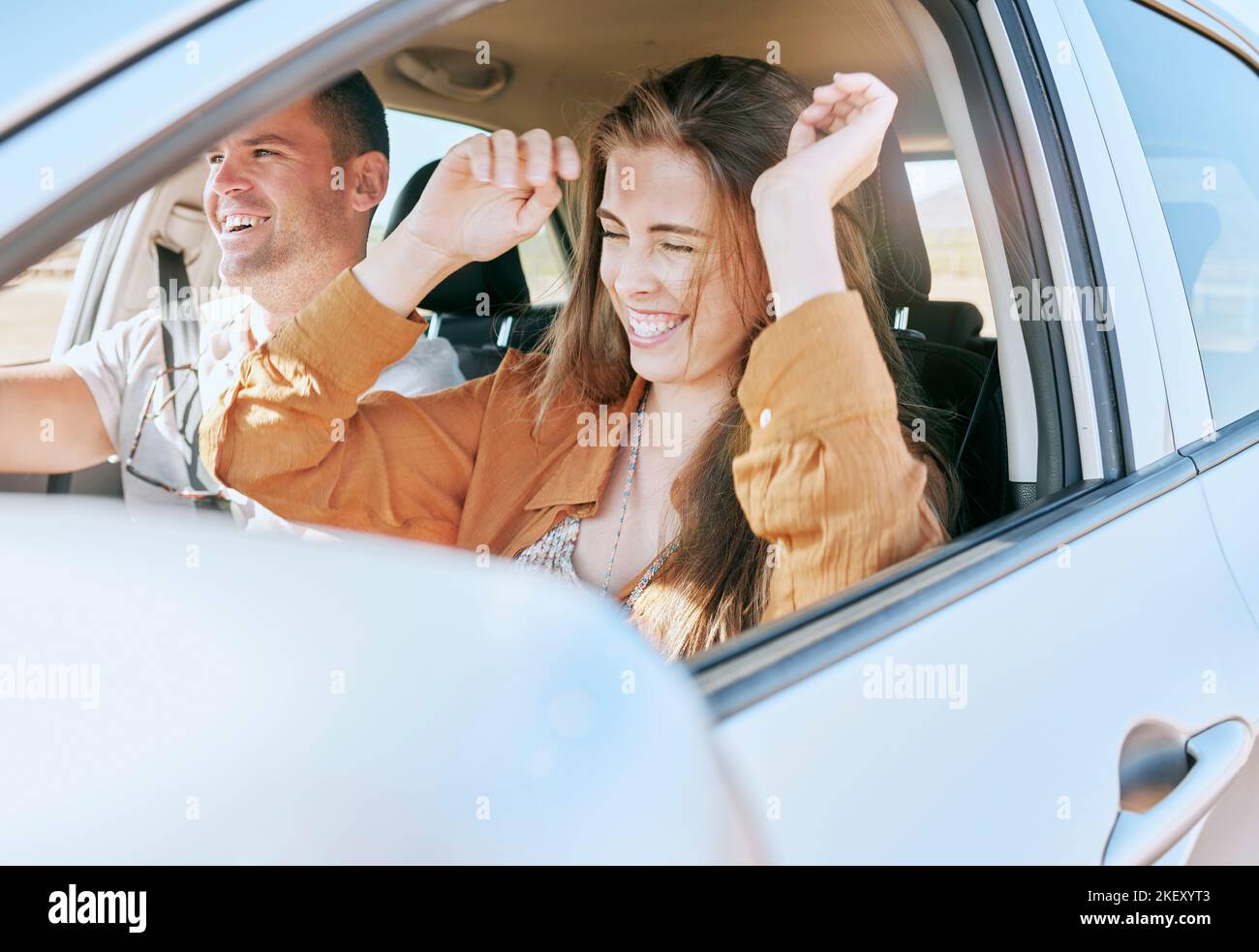 Couple, road trip and smile in car together in traffic for drive ...